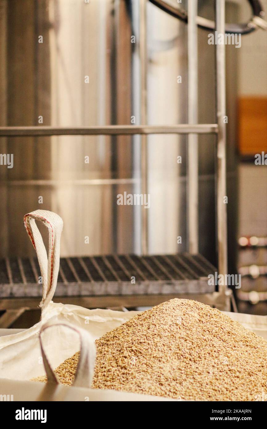 grain, rye flakes at a whiskey distillery with distilling equipment ...