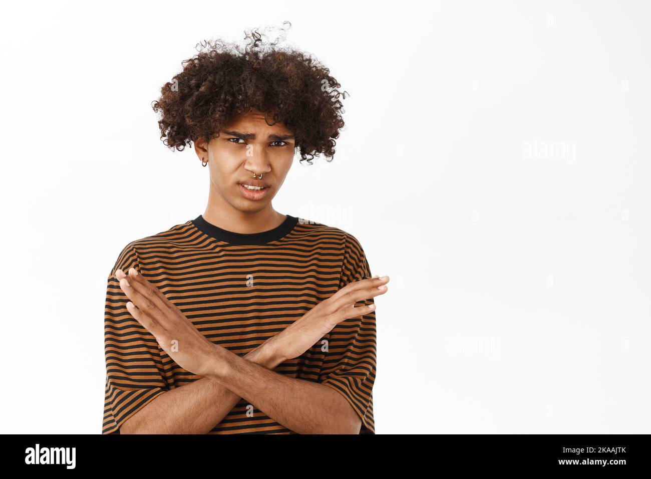 Portrait of guy showing stop, refusal gesture, rejecting smth with ...