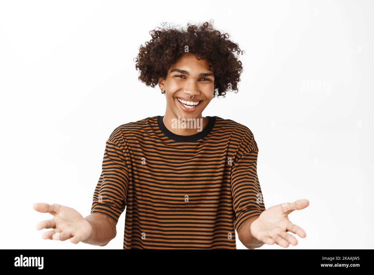 Come to me. Happy young man extends his hands in welcoming gesture and ...