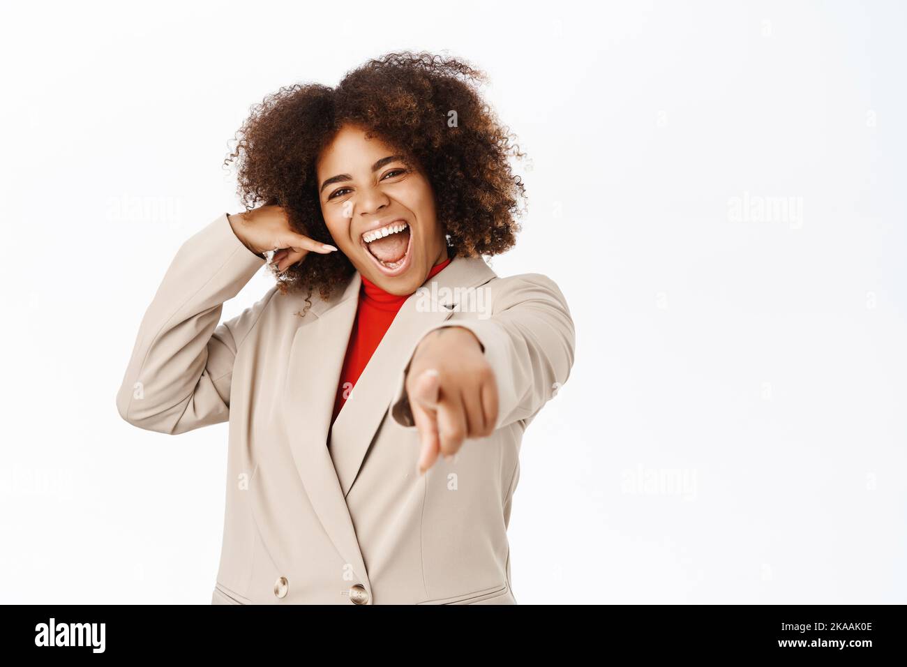 Call us. Smiling office woman, businesswoman pointing finger at camera ...
