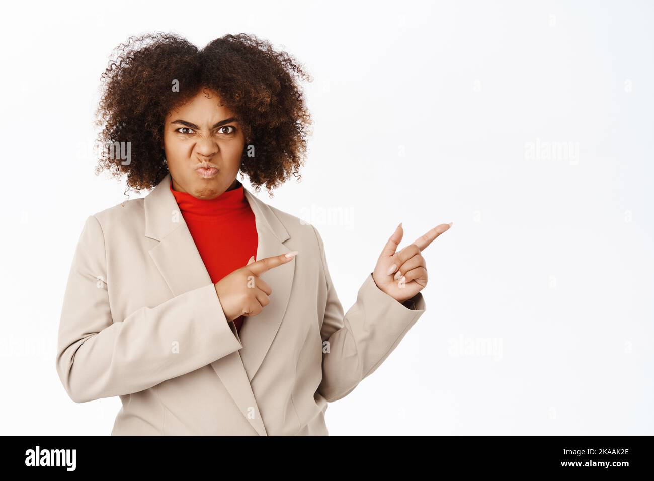 Angry african american saleswoman, grimacing, pointing right, showing ...
