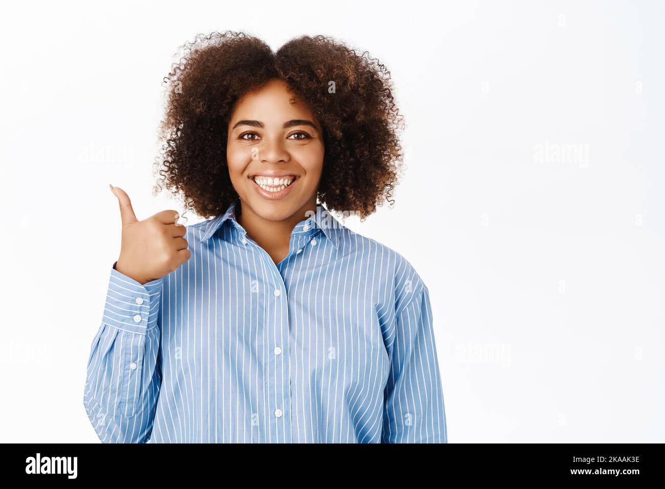 Smiling black woman shows thumbs up, recommends smth, approve and ...