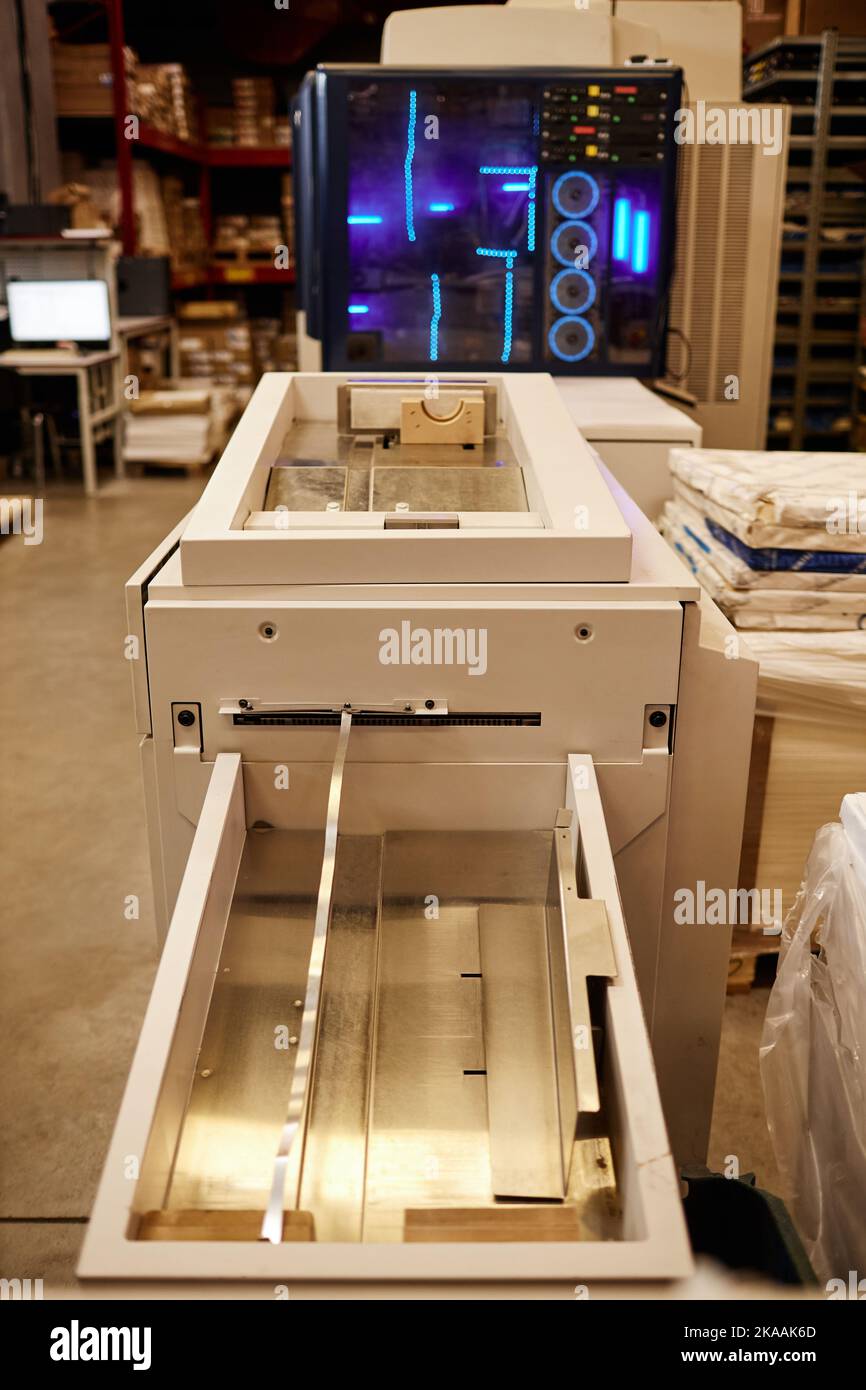 Vertical background image of printing machine in factory workshop, copy ...