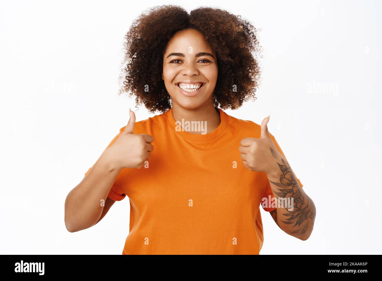 Excellent. Smiling Black woman shows thumbs up with satisfied face ...