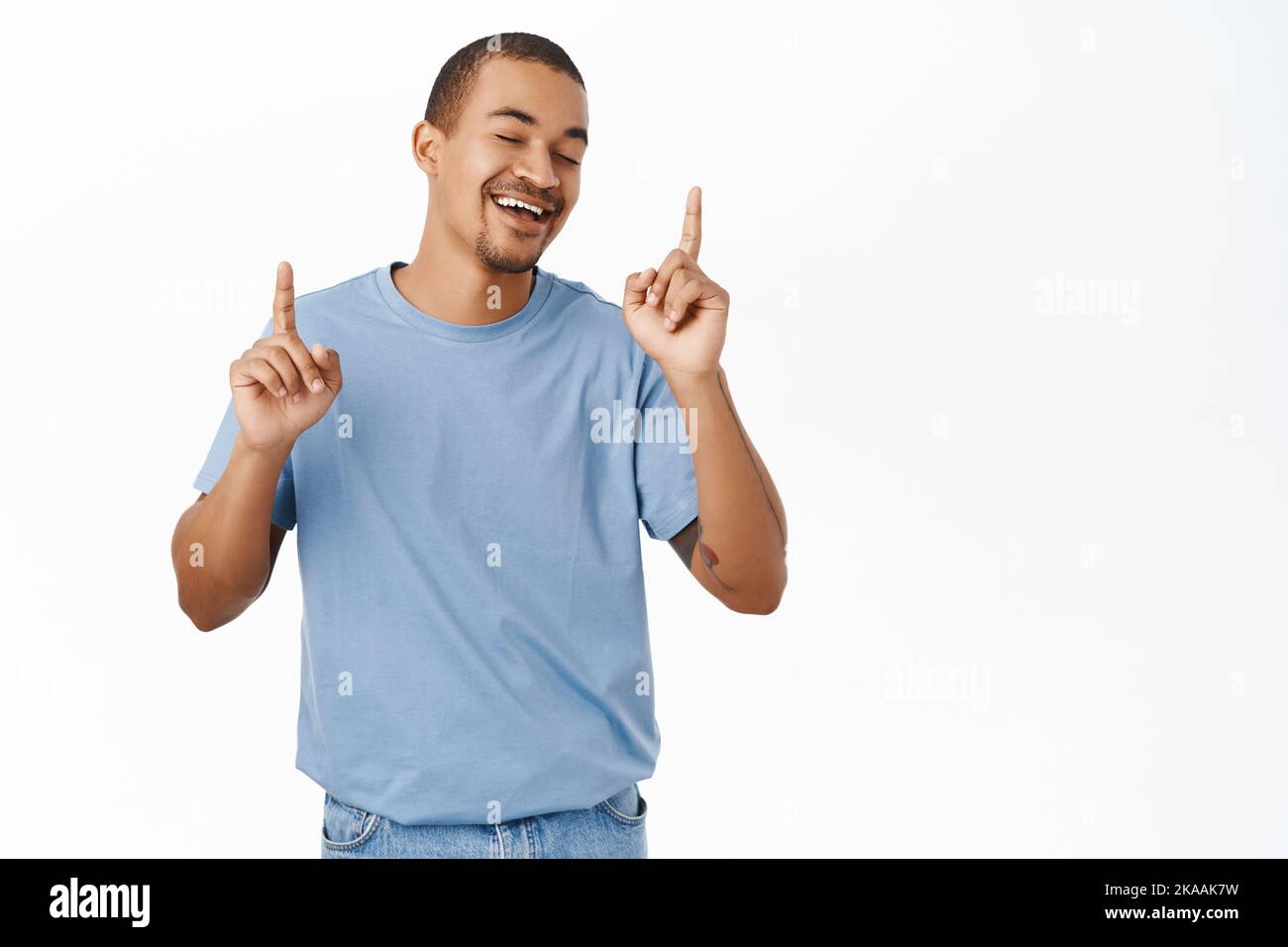 Happy dancing man having fun, enjoying the day, standing in blue tshirt ...