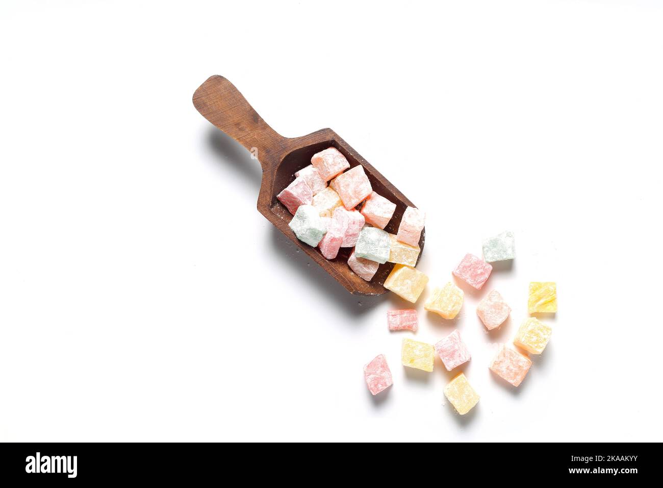 Colorful Turkish Delights in a wooden scoop. isolated on white ...