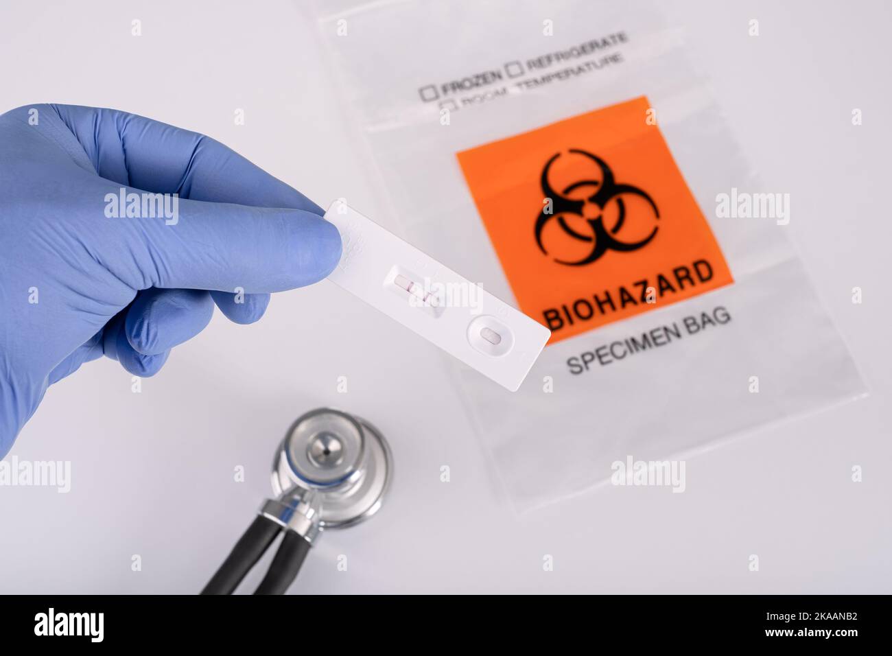 Positive PCR Antigen Rapid Test in specimen bag and stethoscope on ...