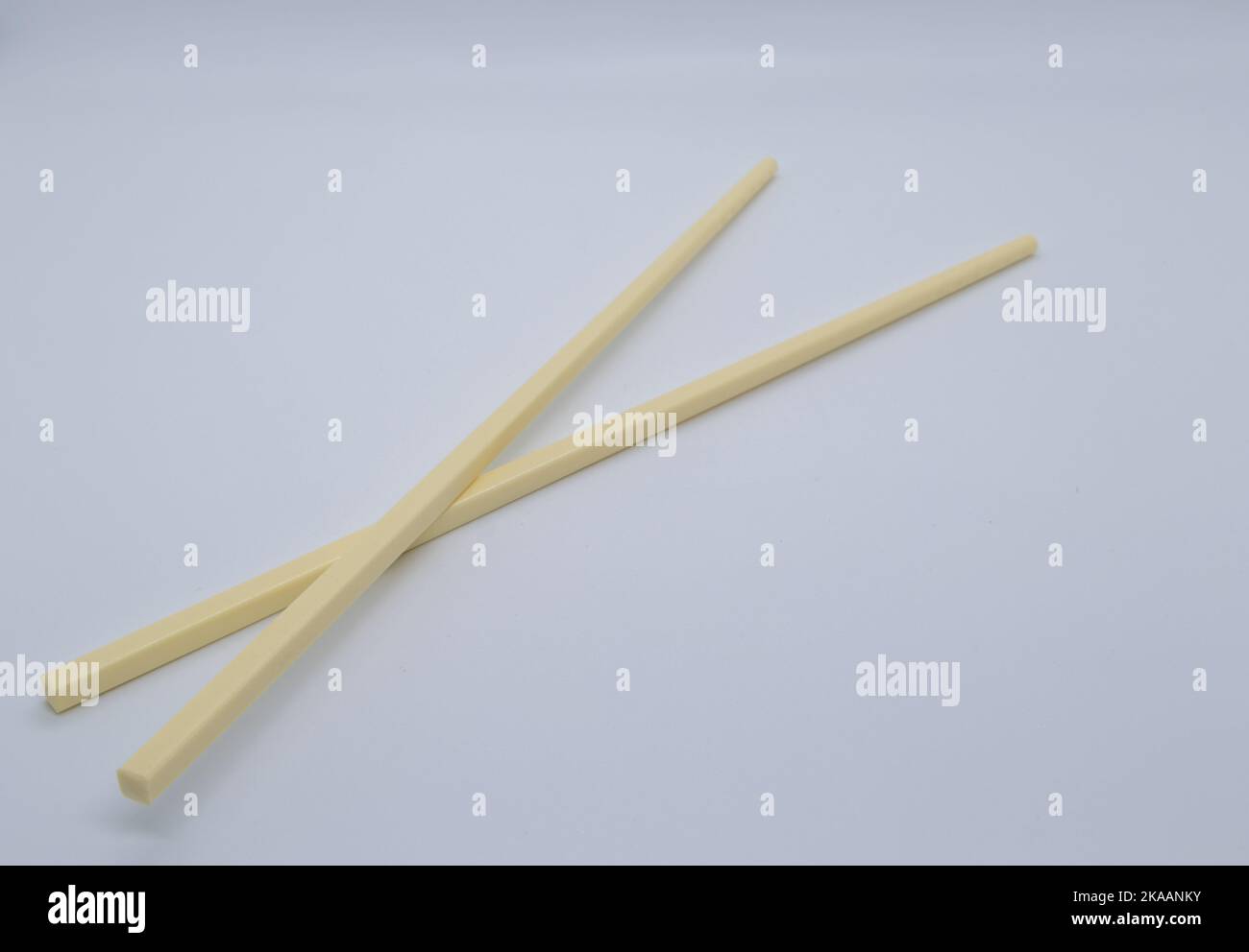 Classic yellow chopsticks on white background Stock Photo - Alamy