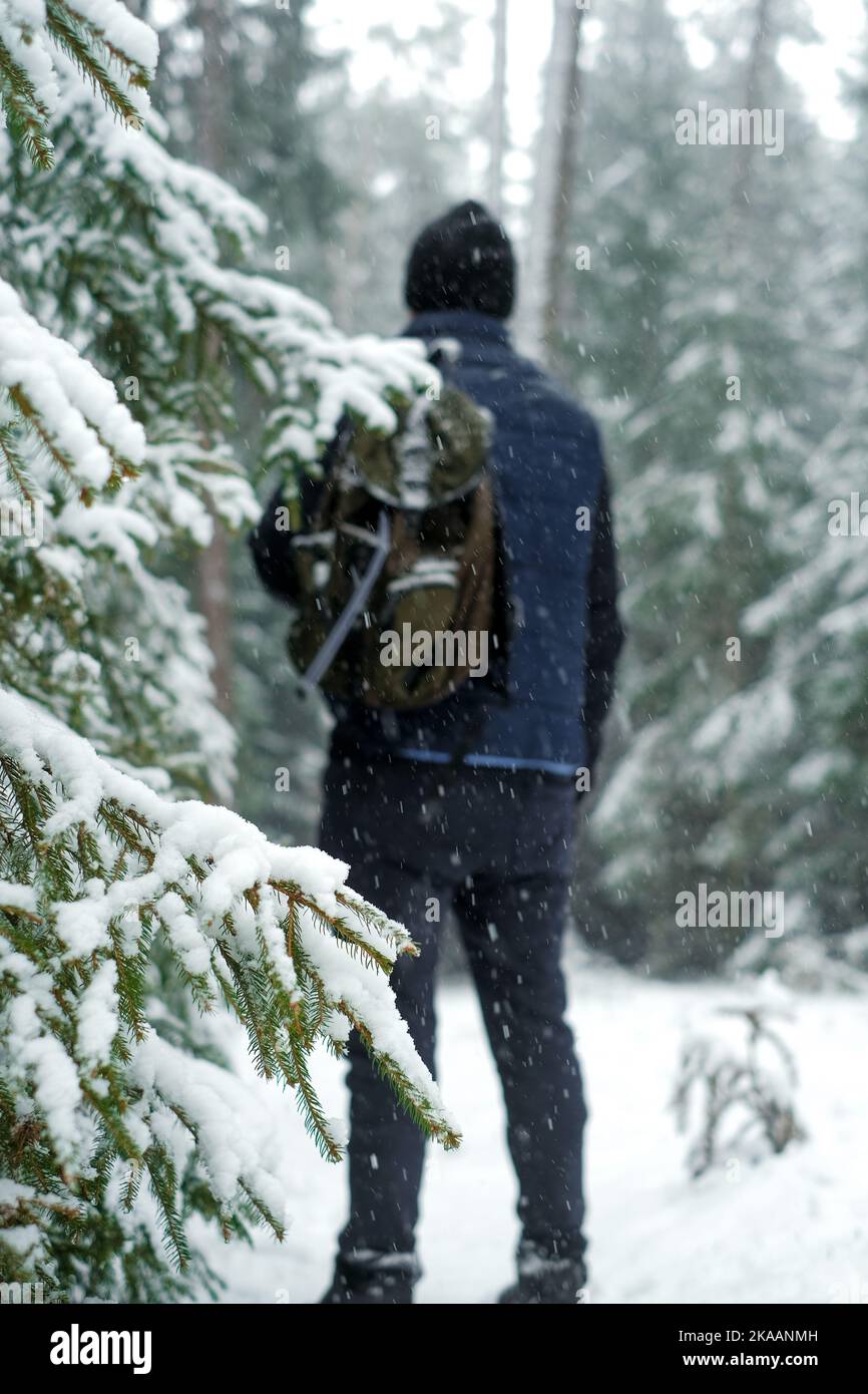 Traveler in winter forest.man with a backpack in snowy weather ...