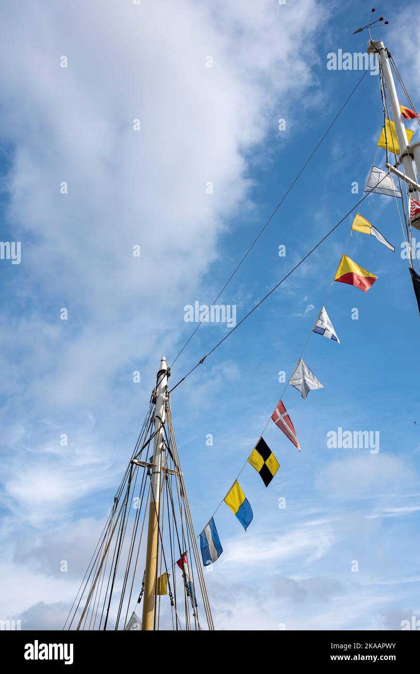 Flags of European countries hang on the mast of the yacht, against the ...