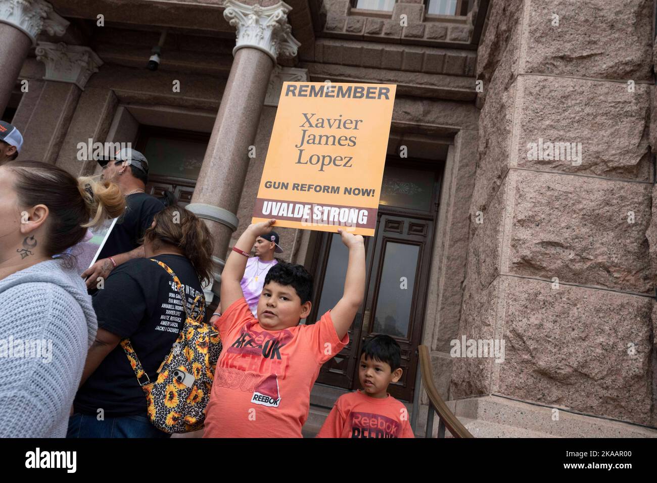 The brothers of Xavier Lopez stand outside the Texas Capitol as ...