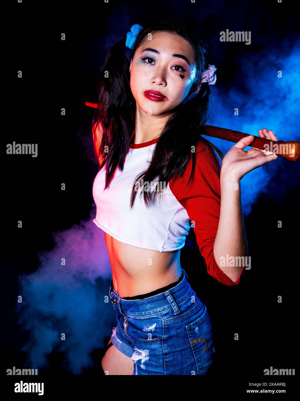 Young Woman in Harlequin Costume Standing in Front of Brightly Lit Fog ...
