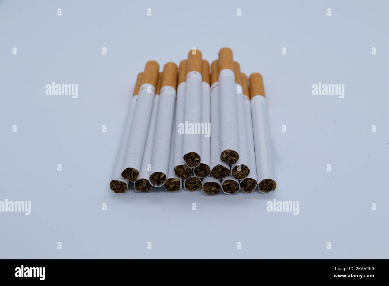 White and orange colored tobacco cigars on white background Stock Photo ...