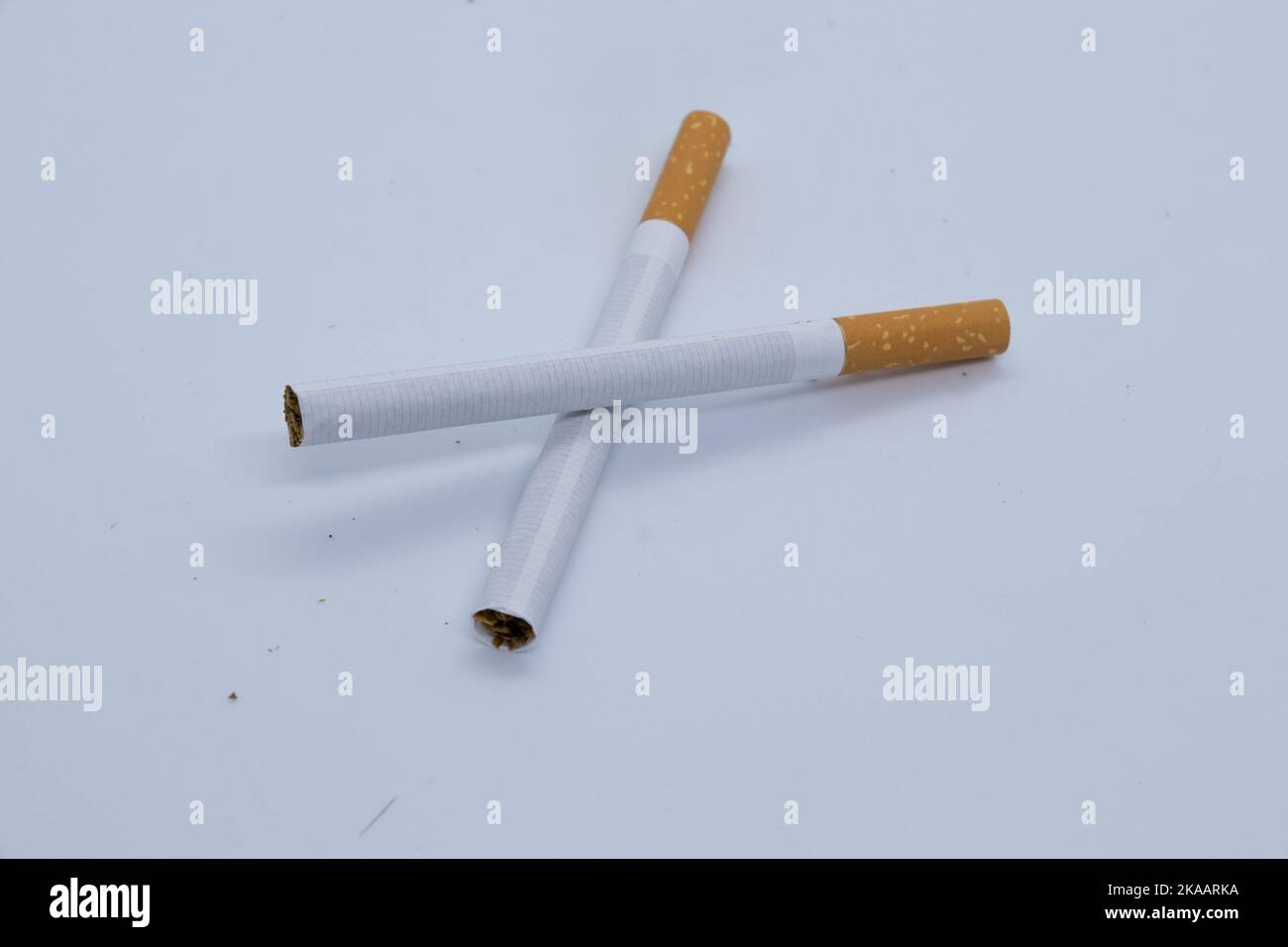 White and orange colored tobacco cigars on white background Stock Photo ...