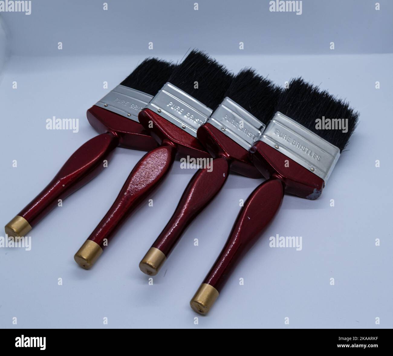 Black and red paint brushes on white background Stock Photo - Alamy