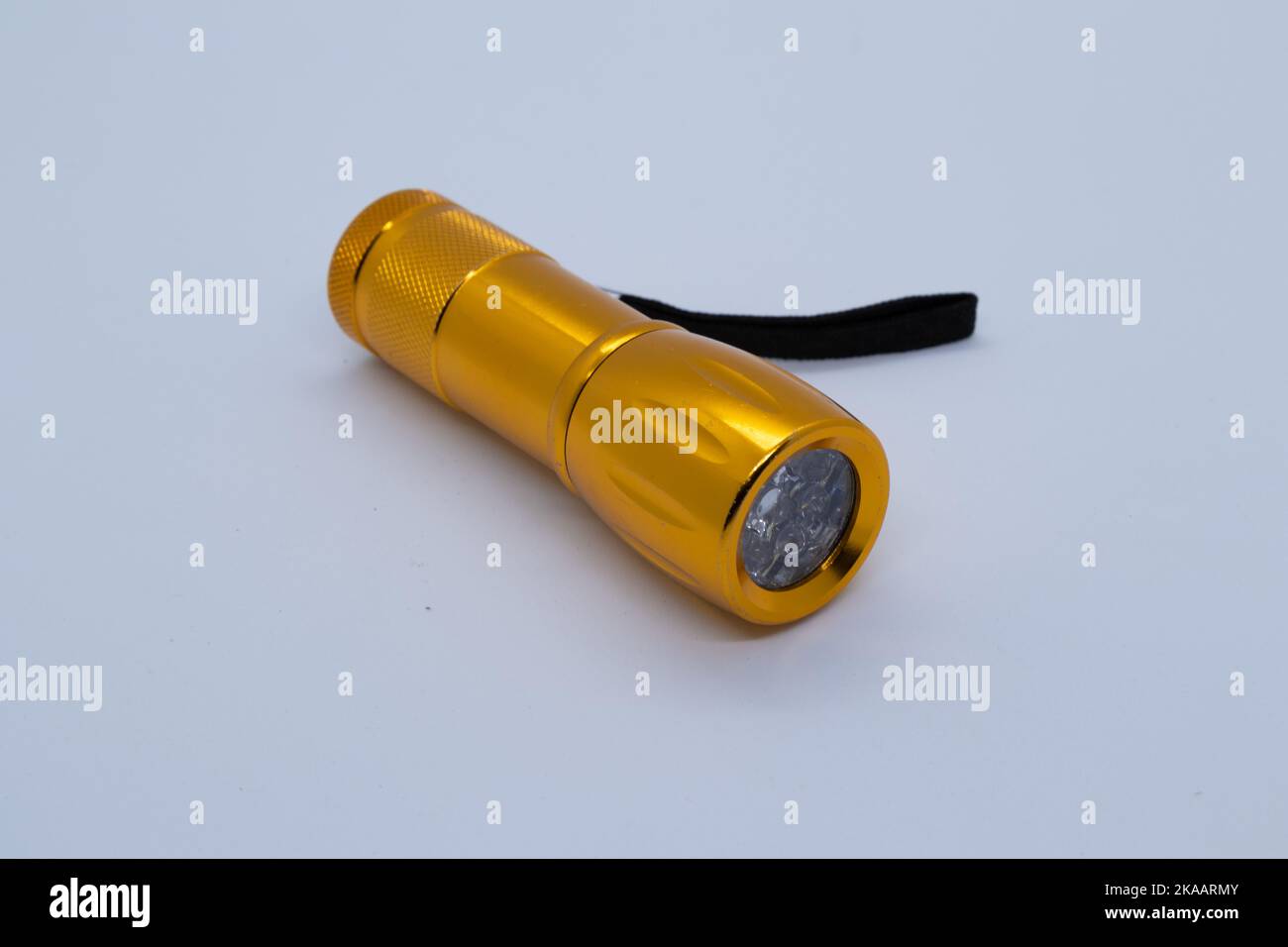 Small orange flashlight on white background Stock Photo - Alamy