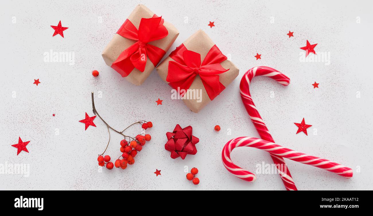 Composition with Christmas gifts, candy canes and rowan berries on ...