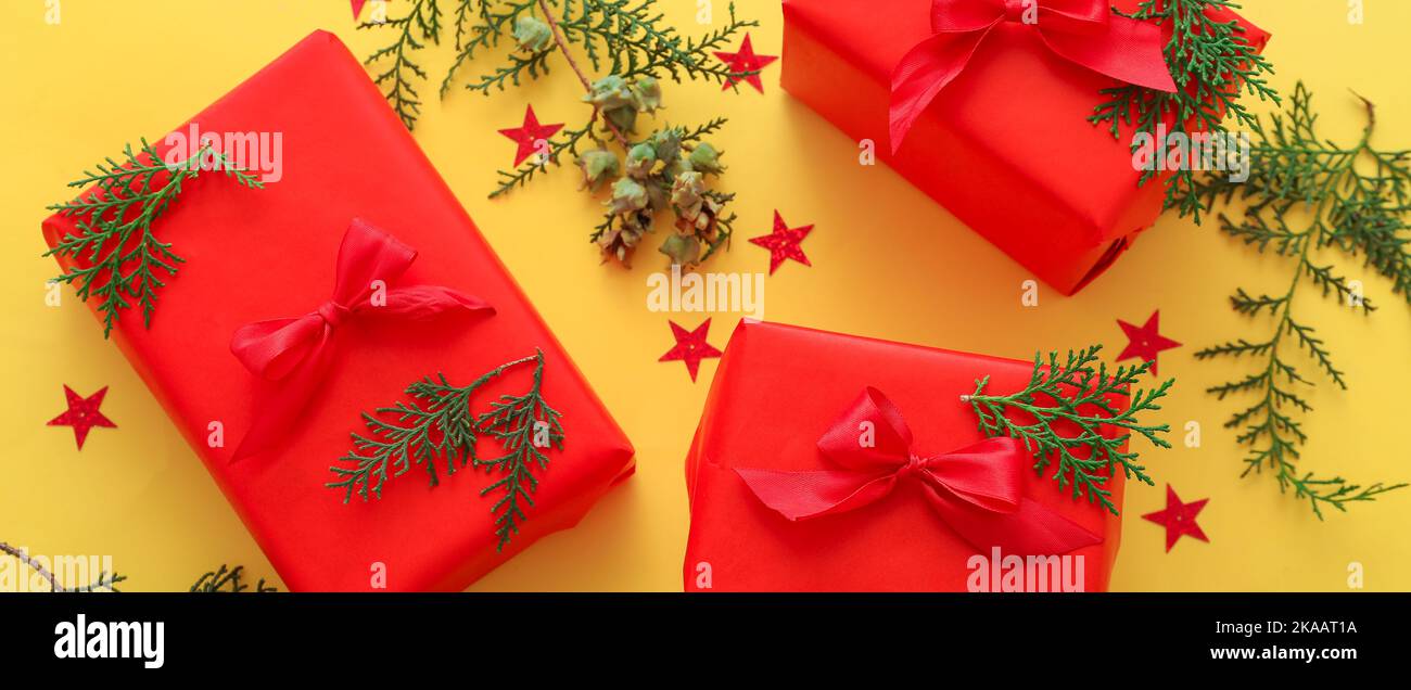 Christmas gifts and thuja branches on yellow background Stock Photo - Alamy