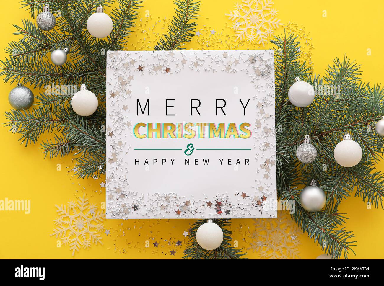 Greeting card with Christmas balls and fir branches on yellow ...