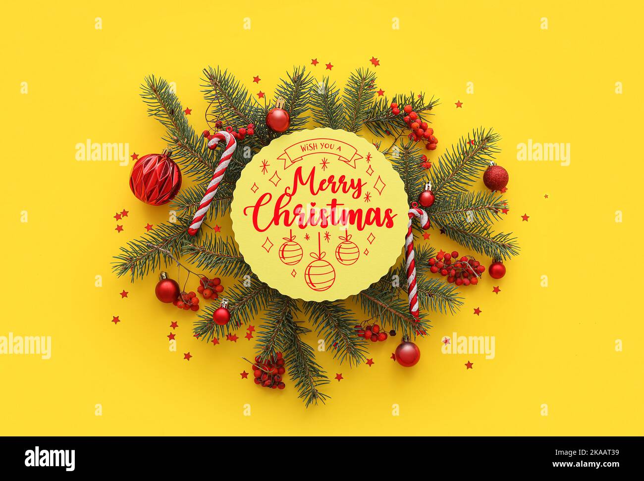 Composition with Christmas greeting card and decorations on yellow ...