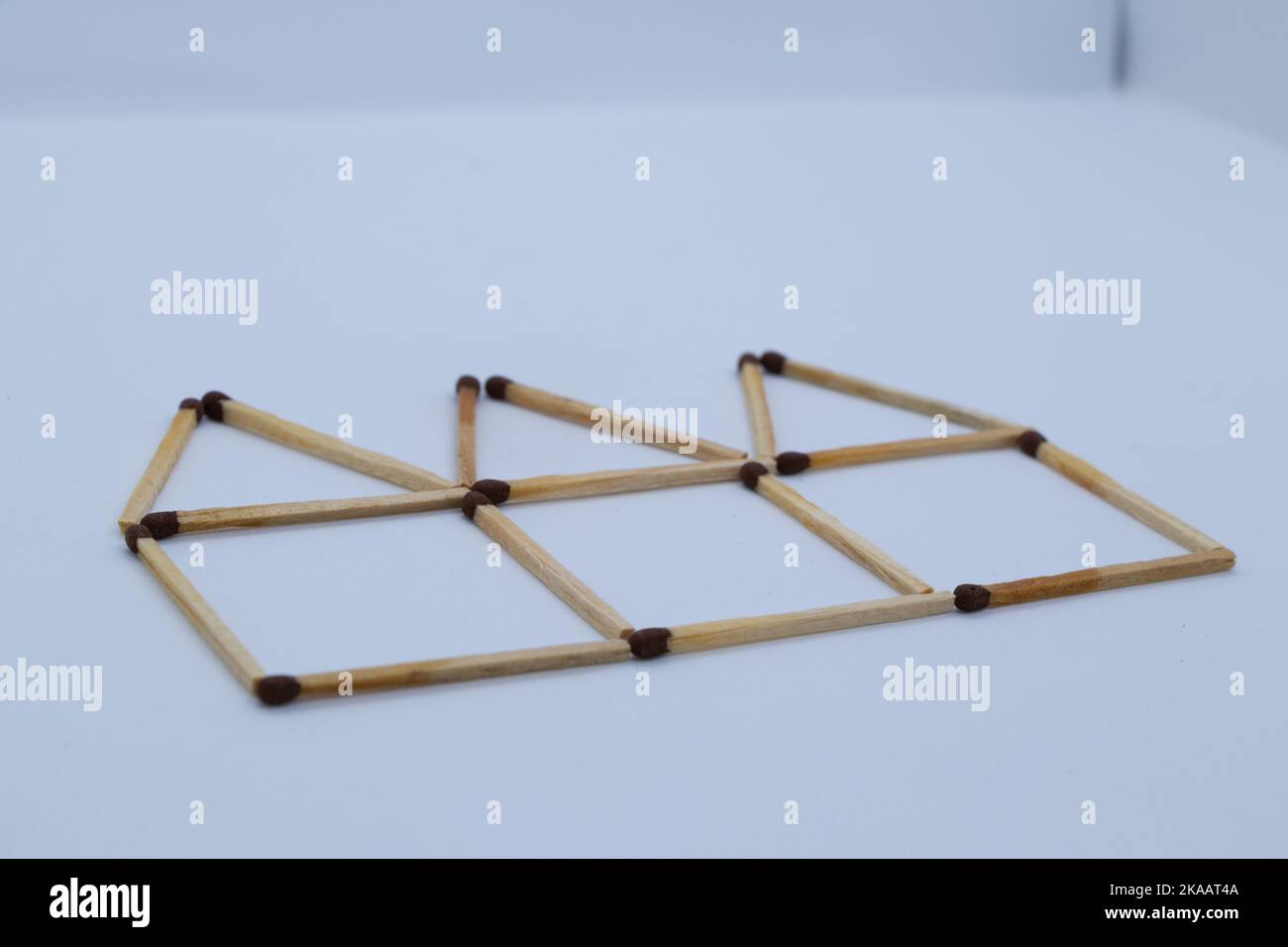 House shaped matches on white background Stock Photo - Alamy