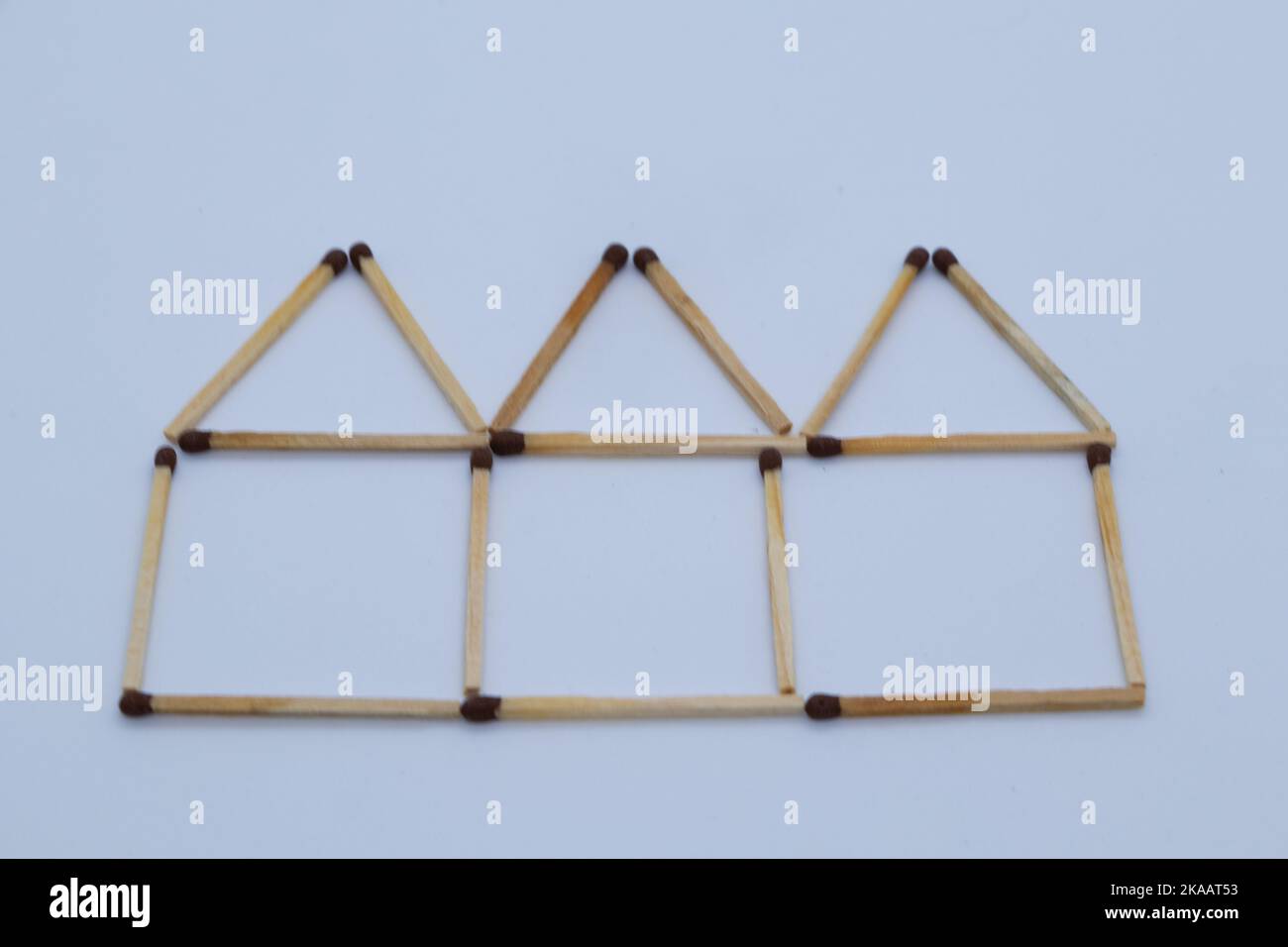 House shaped matches on white background Stock Photo - Alamy
