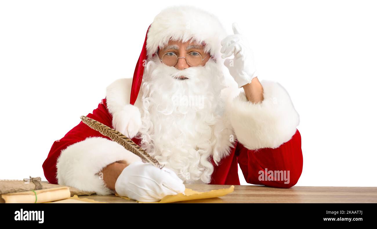 Santa Claus writing letter at table on white background Stock Photo - Alamy