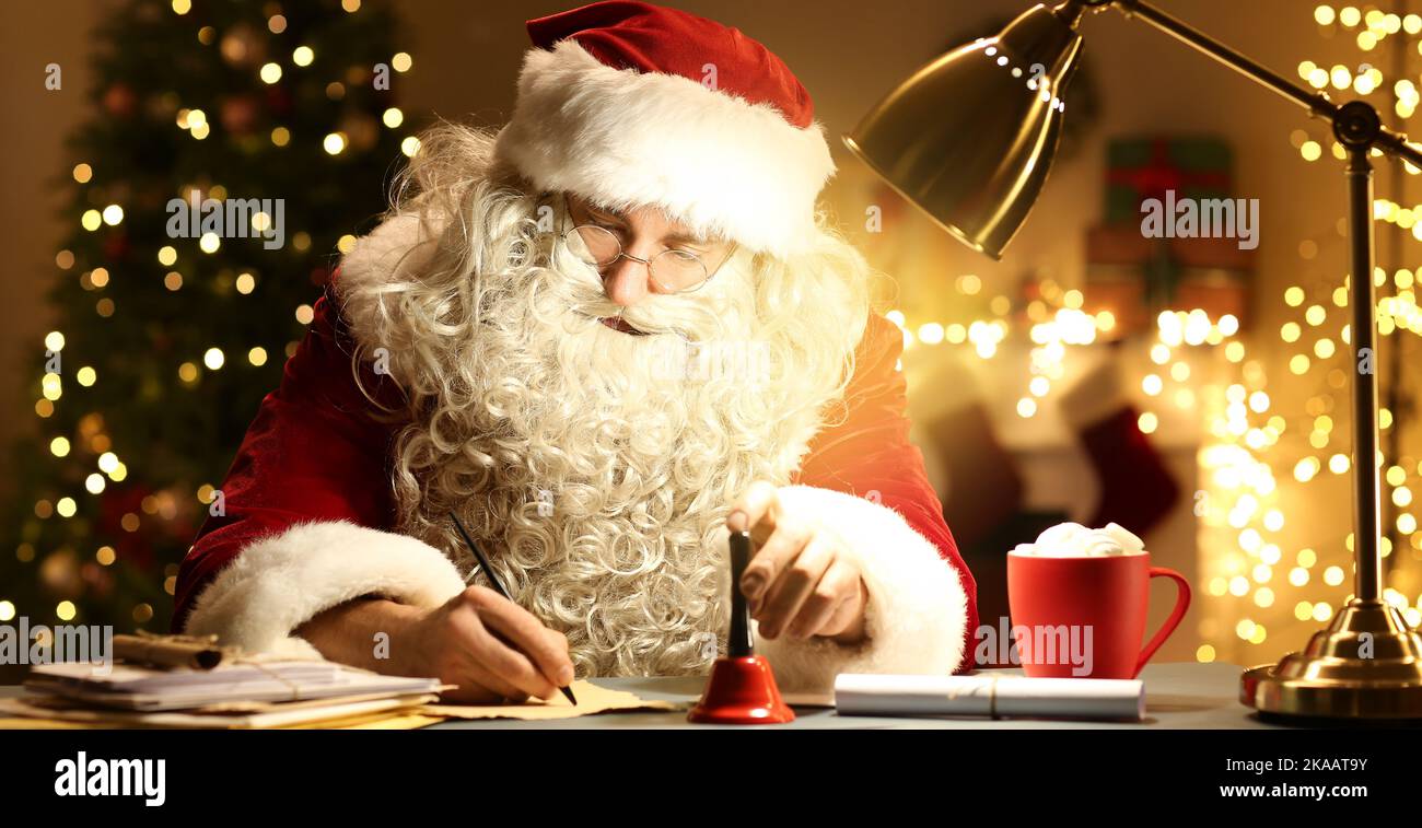 Santa Claus writing letter at night Stock Photo - Alamy