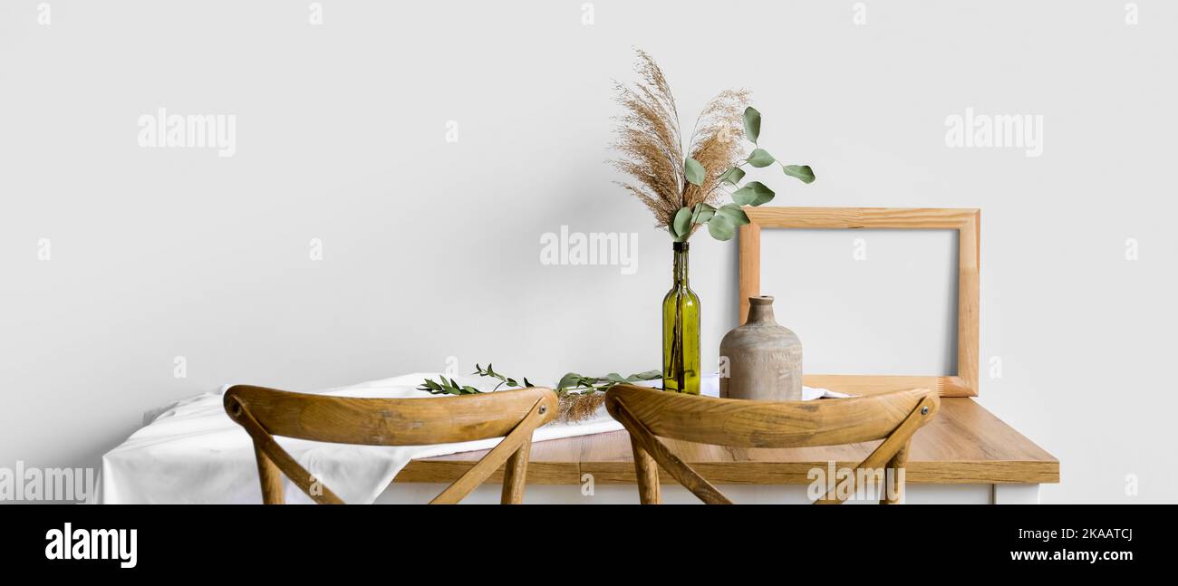 Wooden table with white cloth and beautiful floral decor in room Stock ...