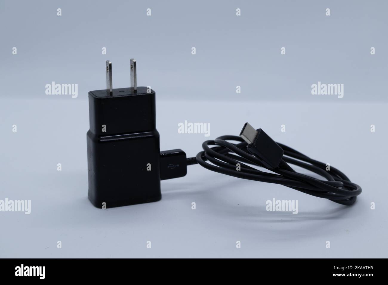 Black charger and cable on white background Stock Photo - Alamy
