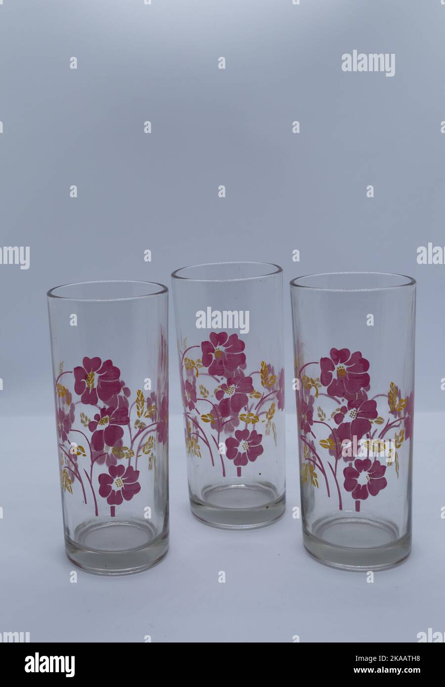 Glass cups with flower image on white background Stock Photo - Alamy