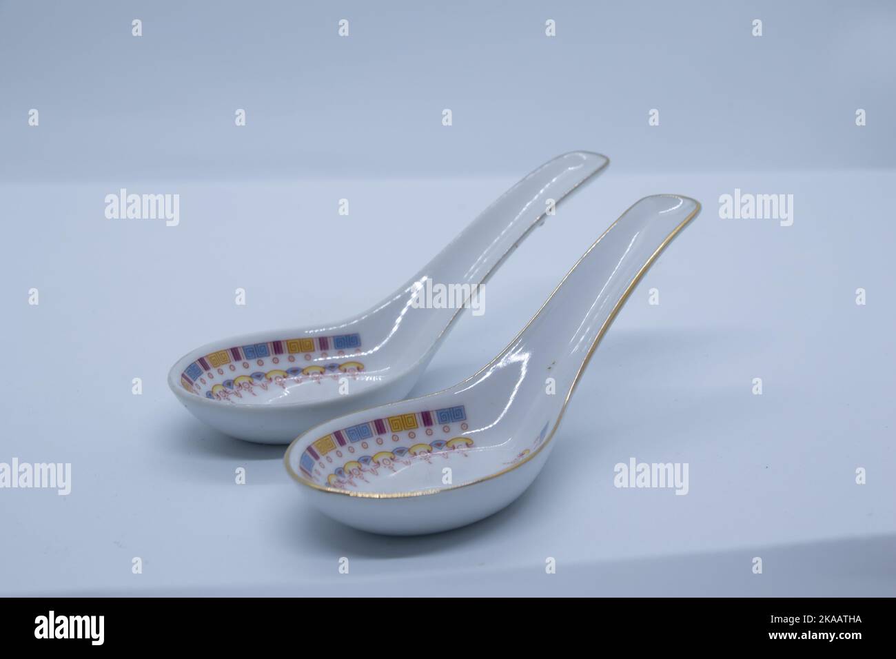 Classic asian patterned soup ladles on white background Stock Photo - Alamy
