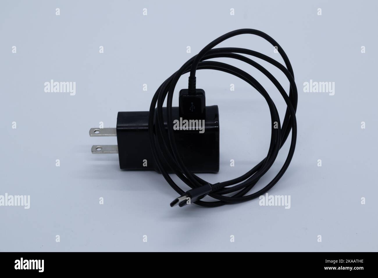 Black charger and cable on white background Stock Photo - Alamy