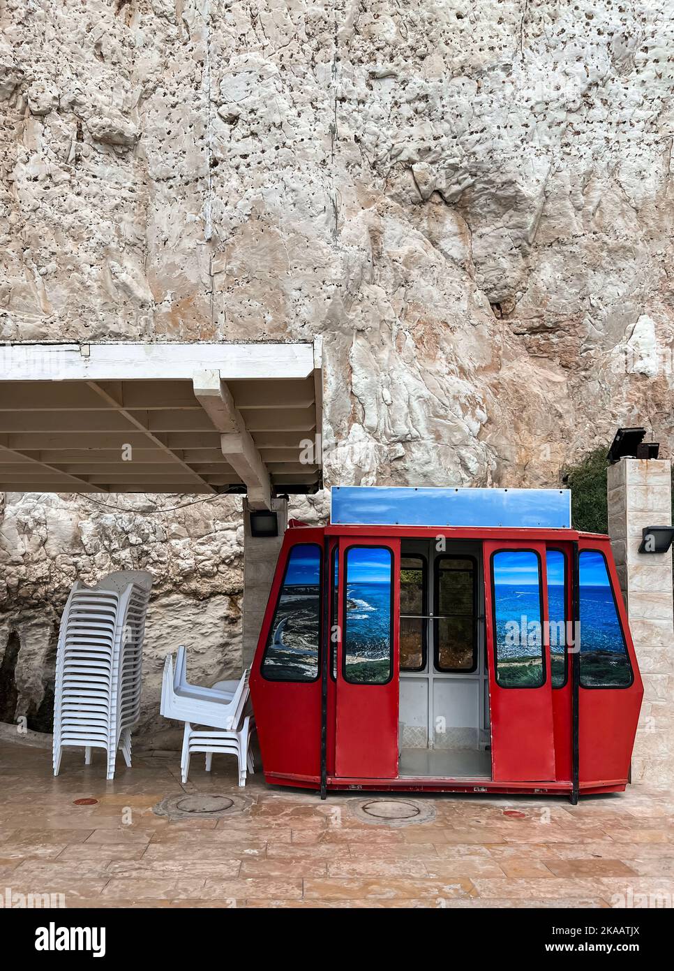 Red cable car cabin near rock Stock Photo - Alamy