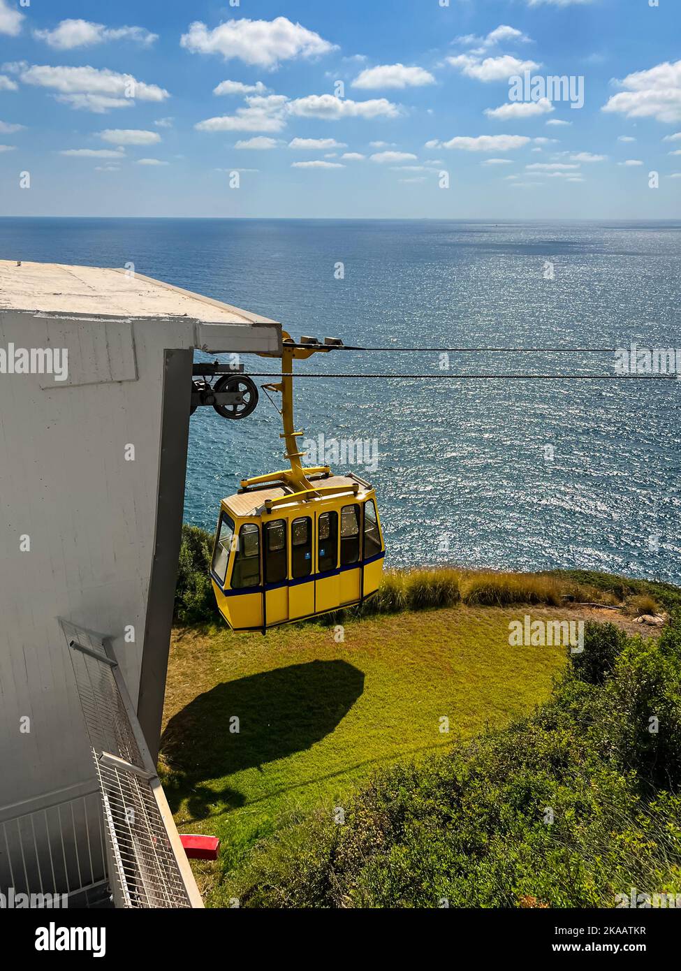 Yellow cable car cabin near station on seaside background Stock Photo ...