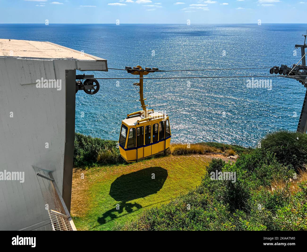 Yellow cable car cabin near station on seaside background Stock Photo ...