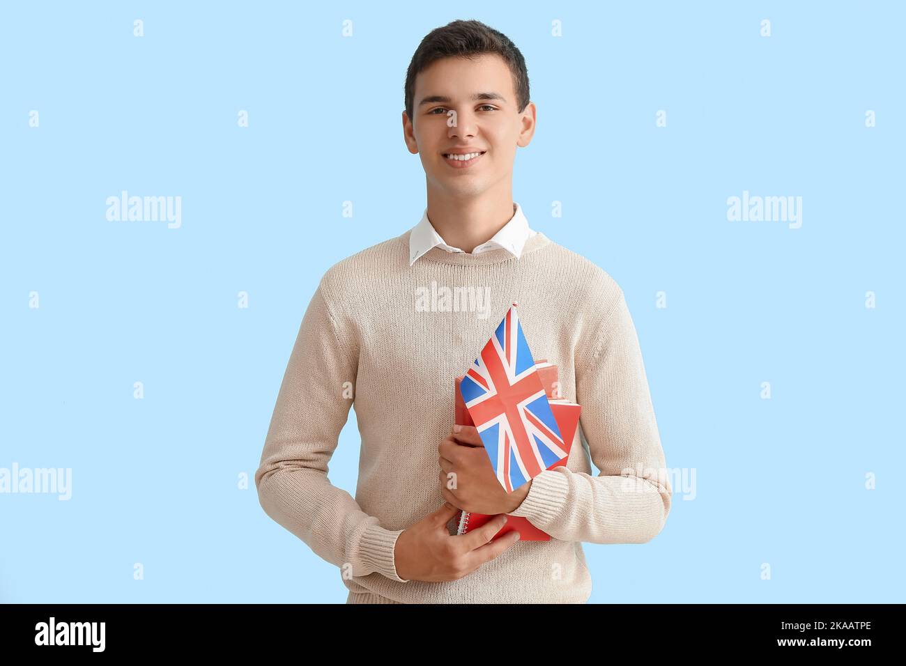Teenage boy with UK flag on blue background Stock Photo - Alamy