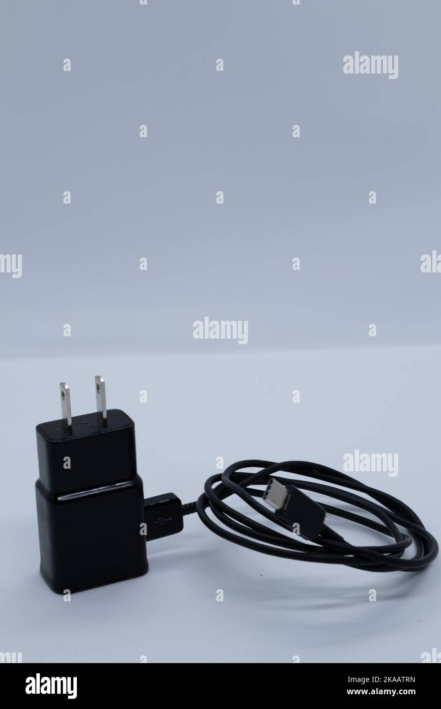Black charger and cable on white background Stock Photo - Alamy