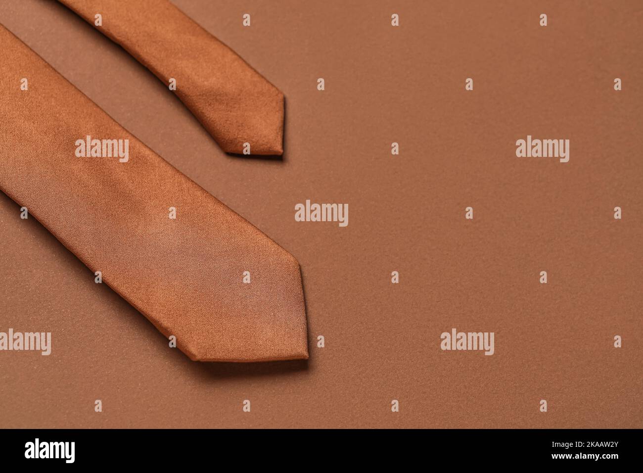 Stylish necktie on brown background Stock Photo - Alamy