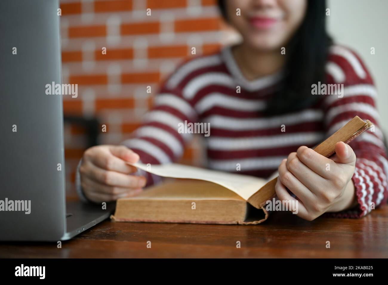 Smart and pretty young Asian female college student researching ...