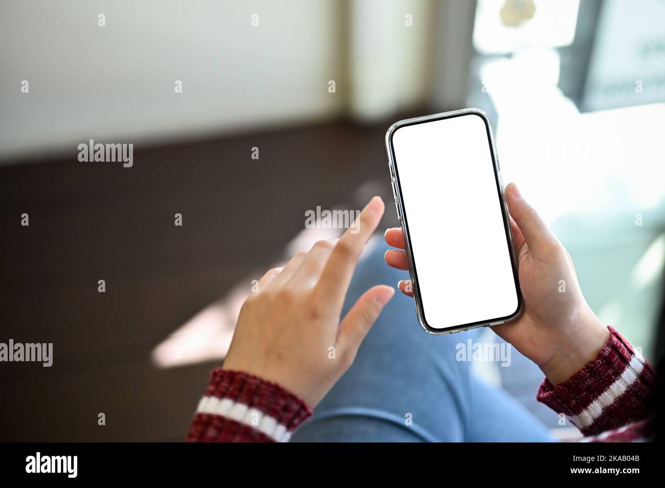 A pretty young Asian woman using her smartphone to chat with her ...