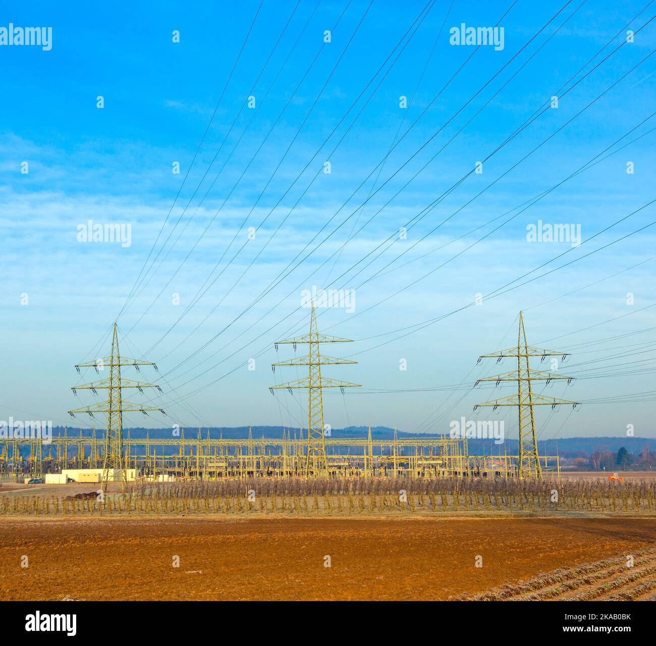 electrical tower in rural landscape with bale of straw Stock Photo - Alamy
