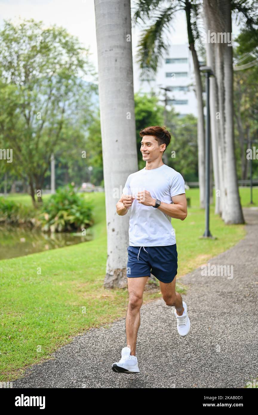 Portrait, Happy and handsome young Asian man in sportswear and ...