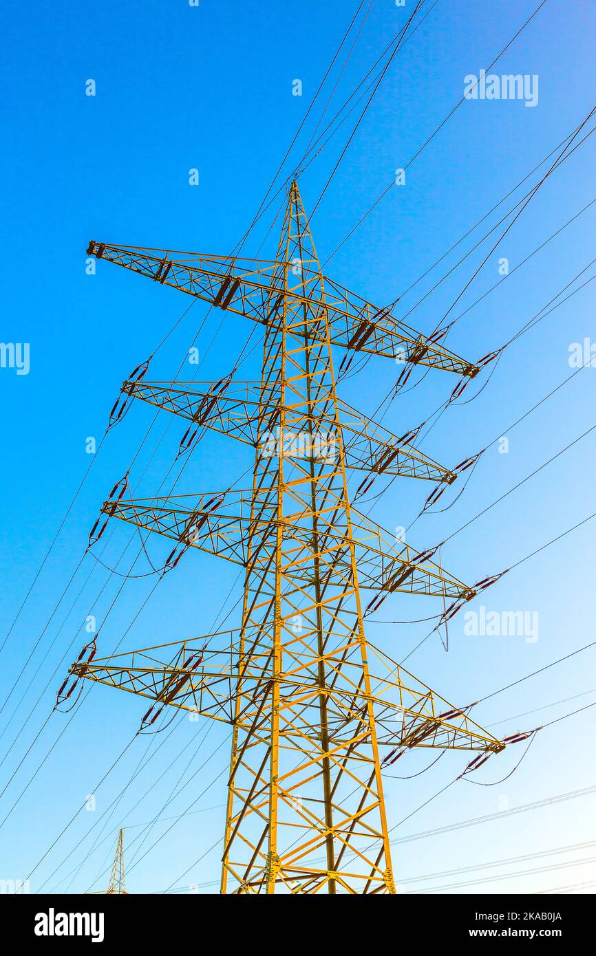 electrical pylon under blue sky, power line cable Stock Photo - Alamy