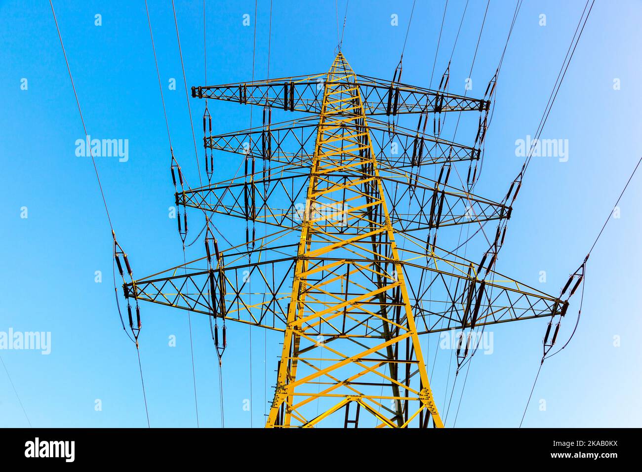 electrical pylon under blue sky, power line cable Stock Photo - Alamy