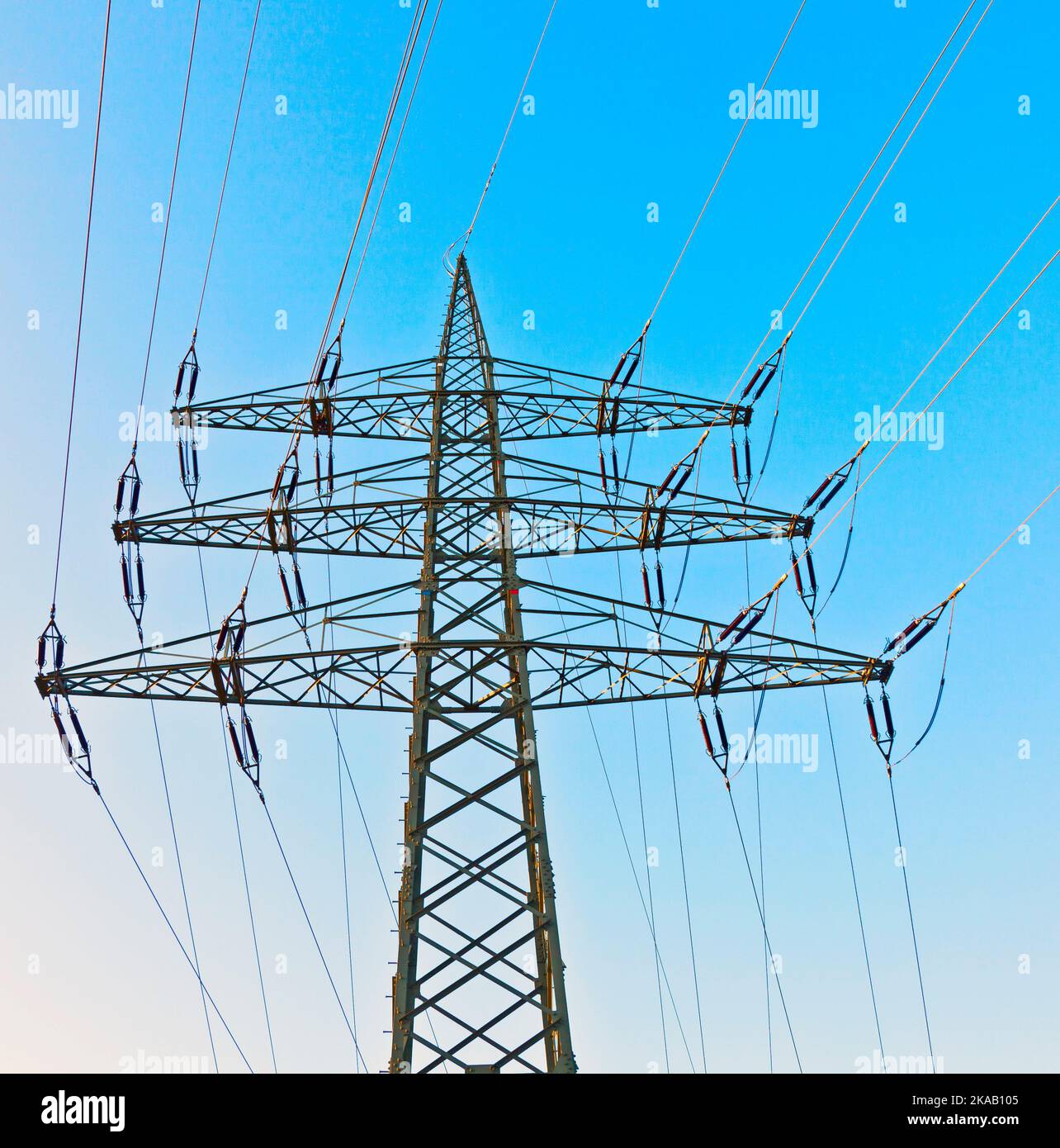 electrical pylon under blue sky, power line cable Stock Photo - Alamy