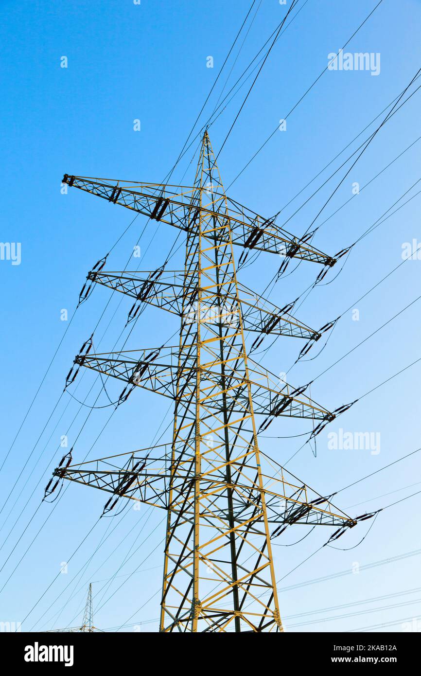 electrical pylon under blue sky, power line cable Stock Photo - Alamy