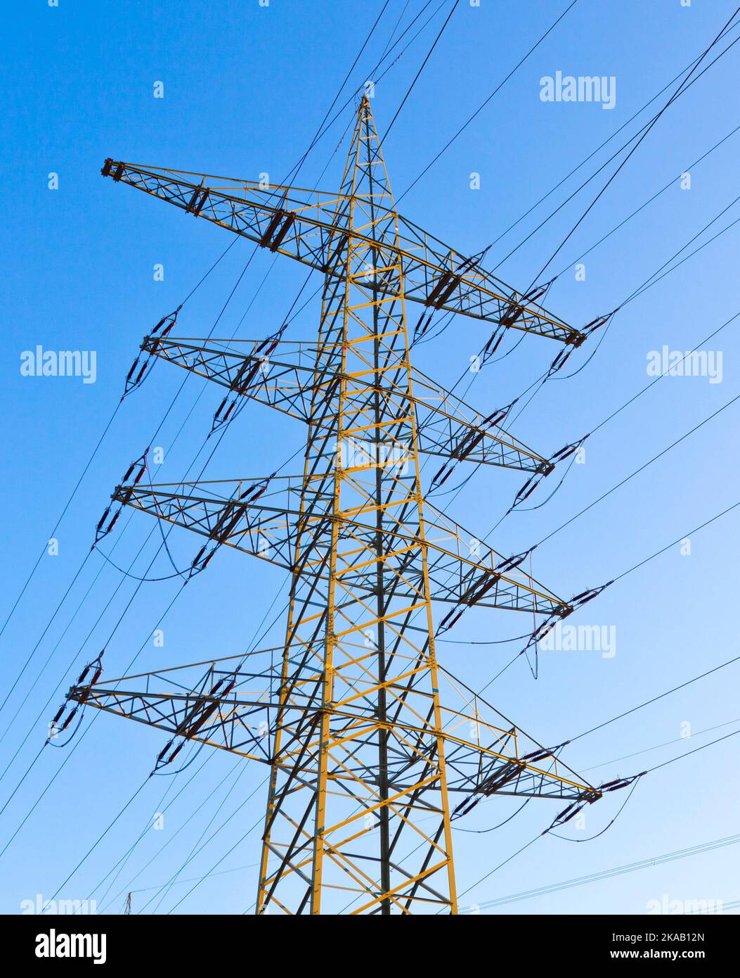 electrical pylon under blue sky, power line cable Stock Photo - Alamy