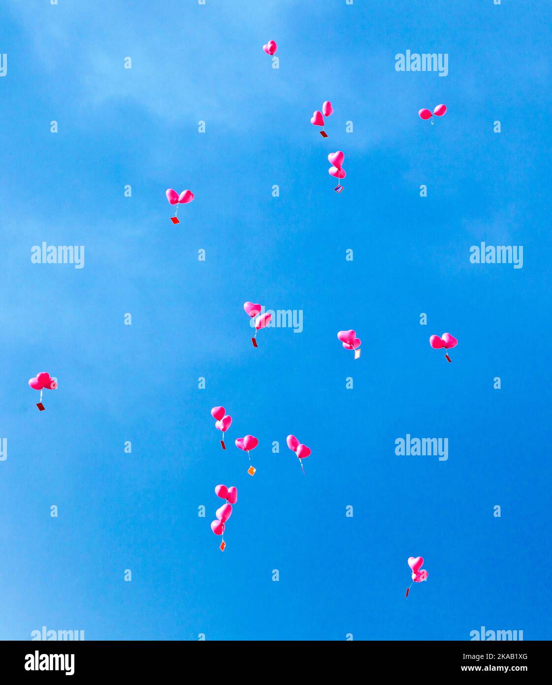 Red balloons with the messages in the blue sky Stock Photo - Alamy