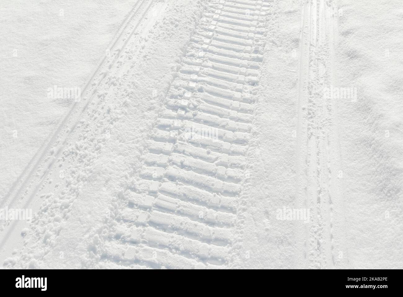 Trail of snow scooter wheel in fresh snow Stock Photo - Alamy